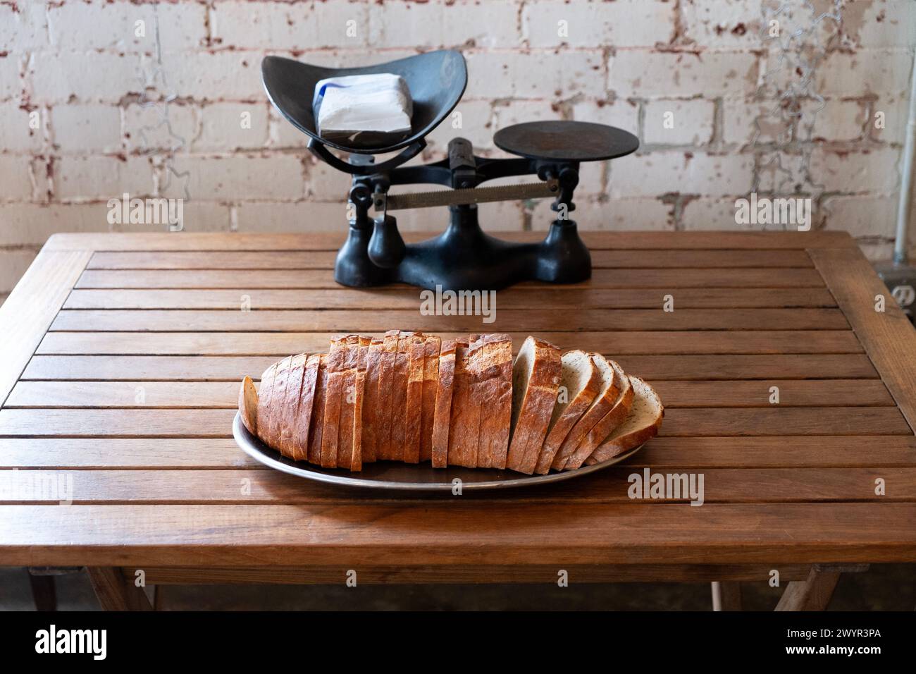 Loaf of sliced bread on wood table with scale Stock Photo - Alamy