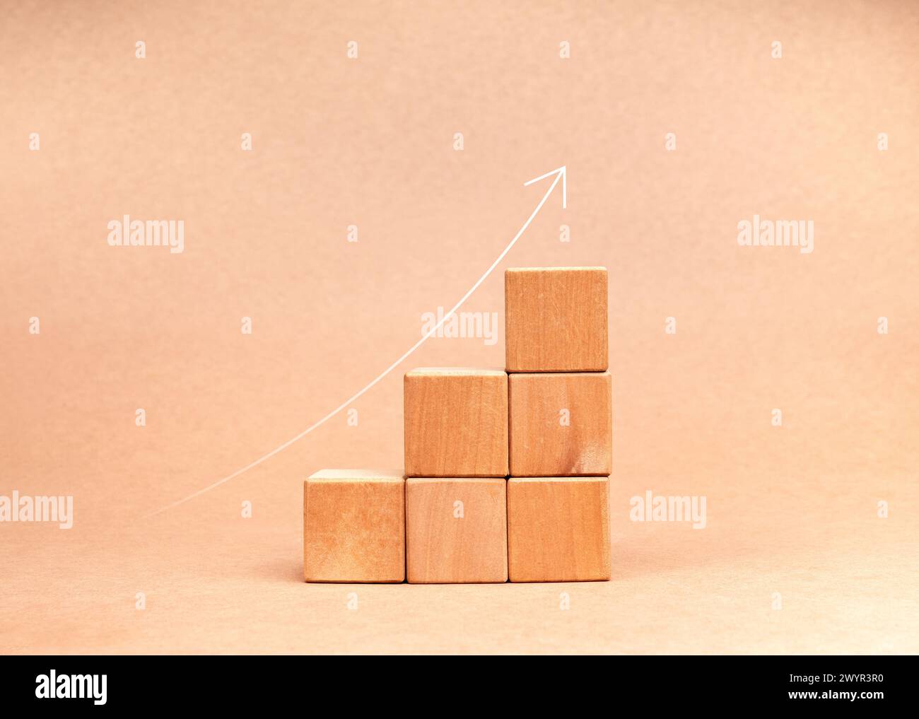 Rising up thin arrow on wooden cube blocks, minimalist bar graph chart ...