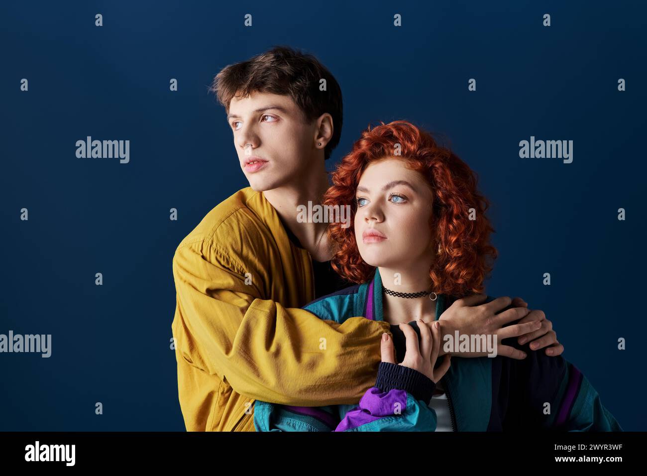 beautiful woman and her boyfriend in vibrant clothes hugging and ...