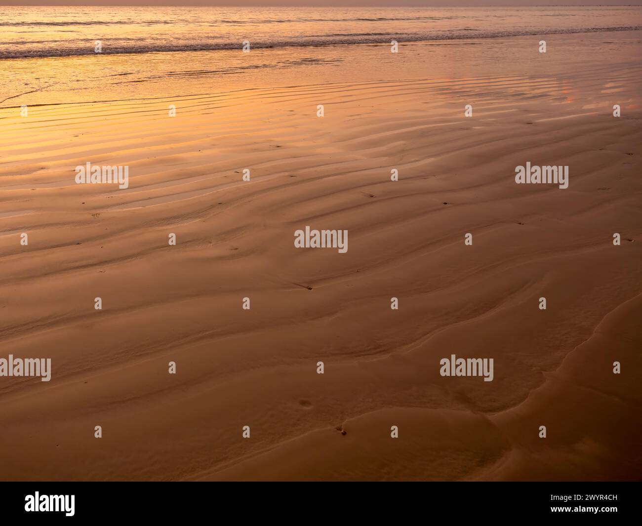 Sandy pattern and curved texture on the beach created by waves and sea ...