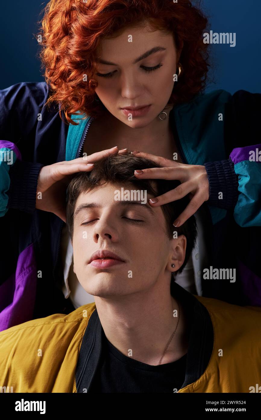 good looking young couple in stylish vibrant attires hugging warmly on ...