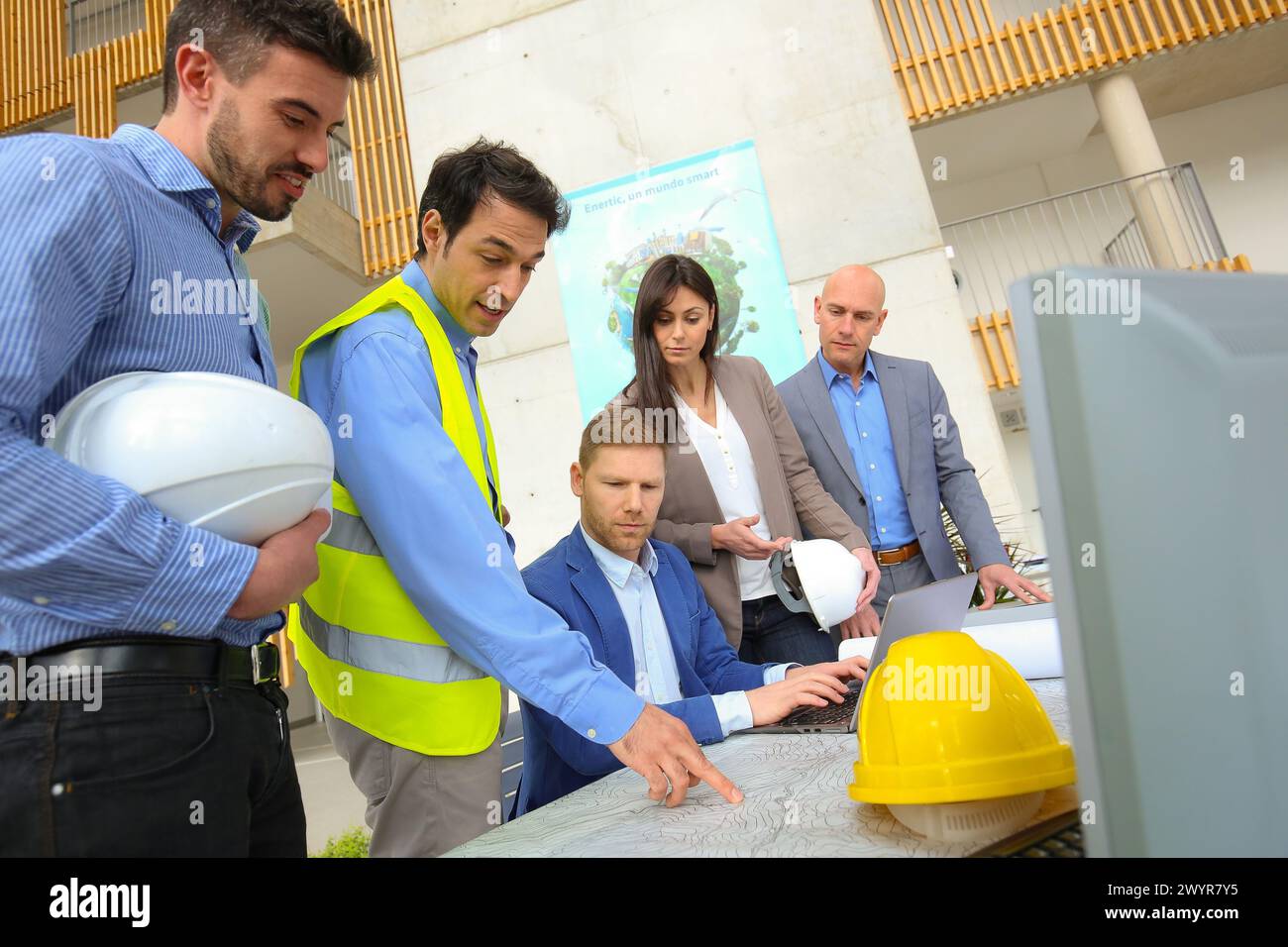 Engineers looking at map Stock Photo - Alamy