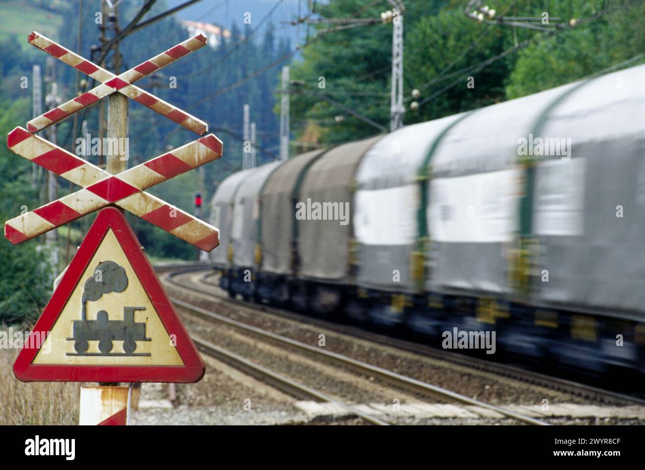 Train and level crossing sign Stock Photo - Alamy