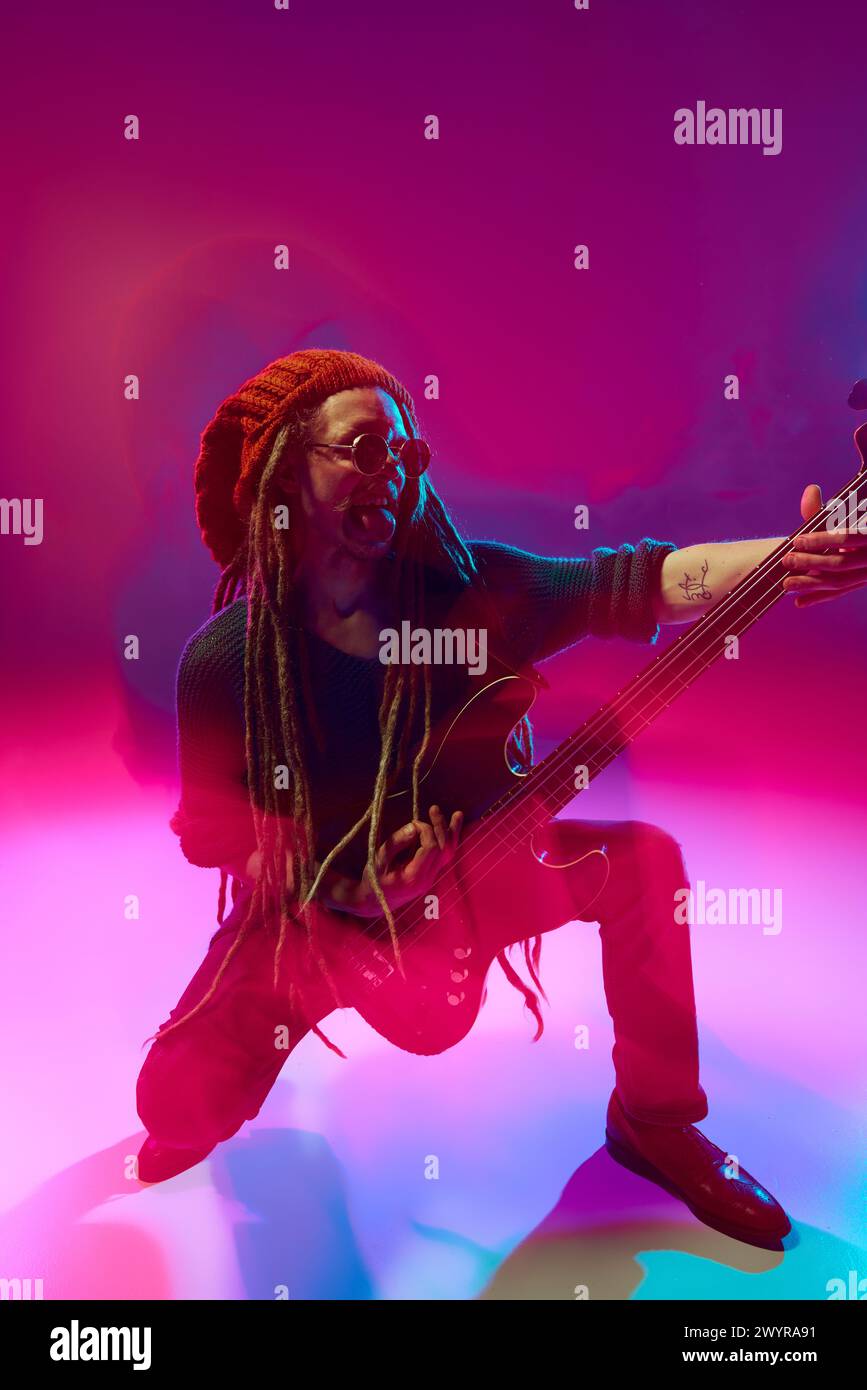 Atmospheric dynamic scene of guitarist with dreadlocks, male musician ...