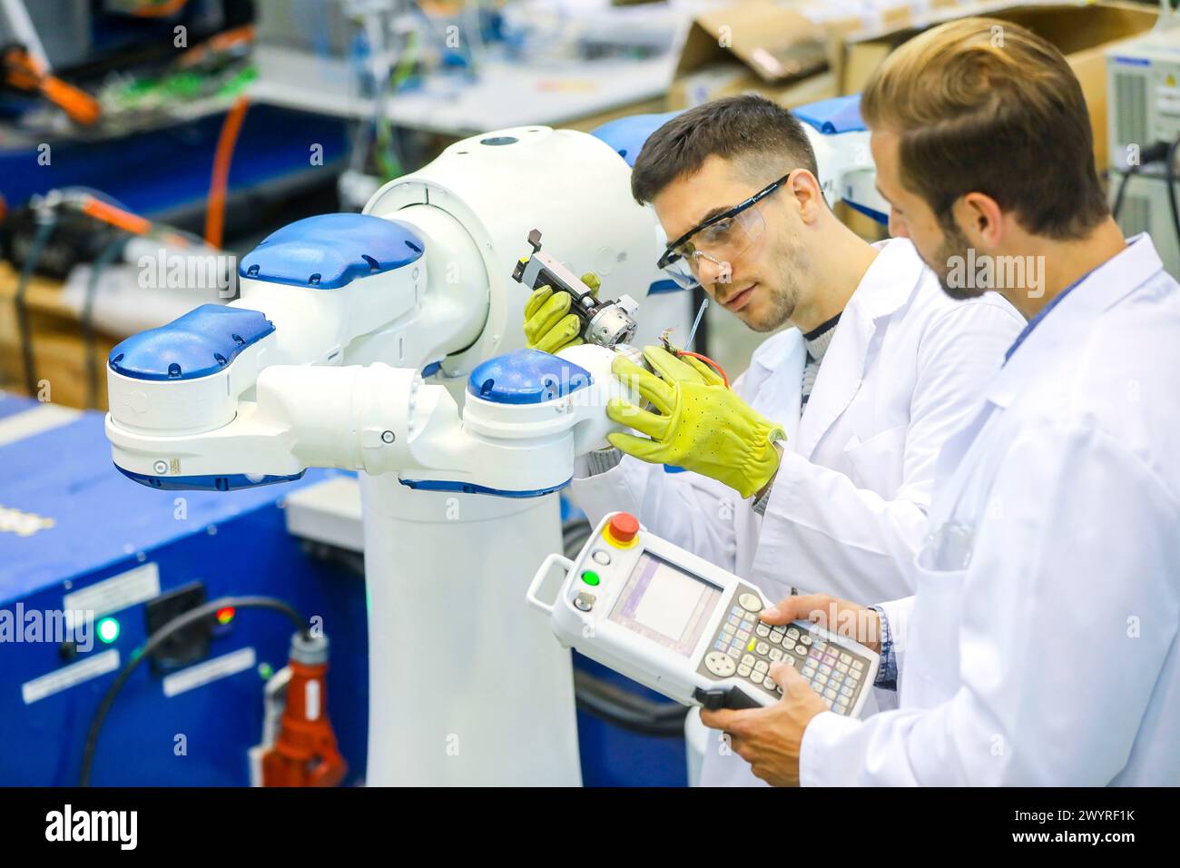 Two-arm robot for industrial handling. Researchers working on robot ...
