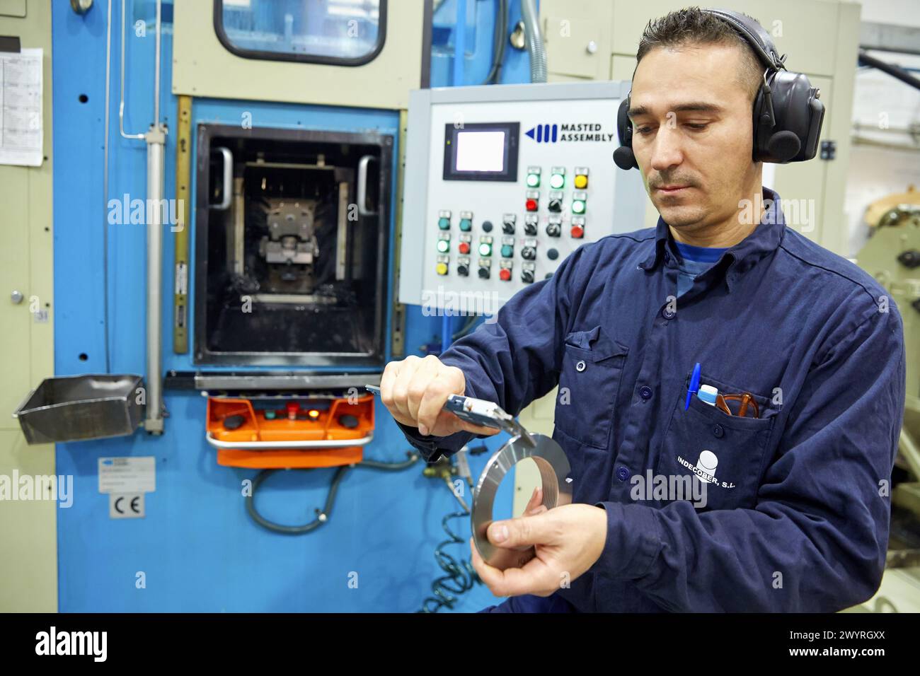 Worker measuring with caliper. Locking nut. Transfer machining ...