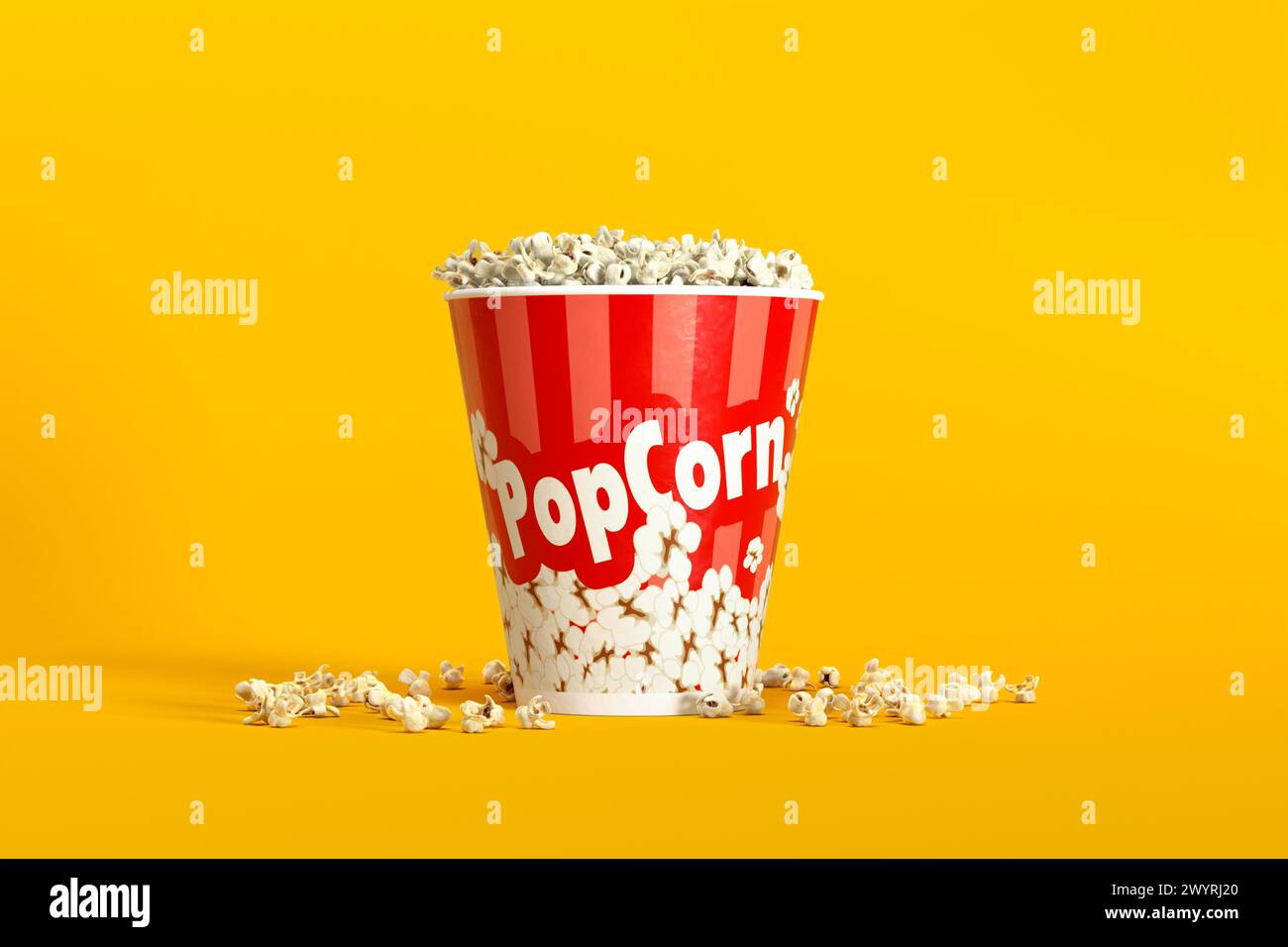 Big bucket of popcorn with spilled corns on yellow background. 3D ...