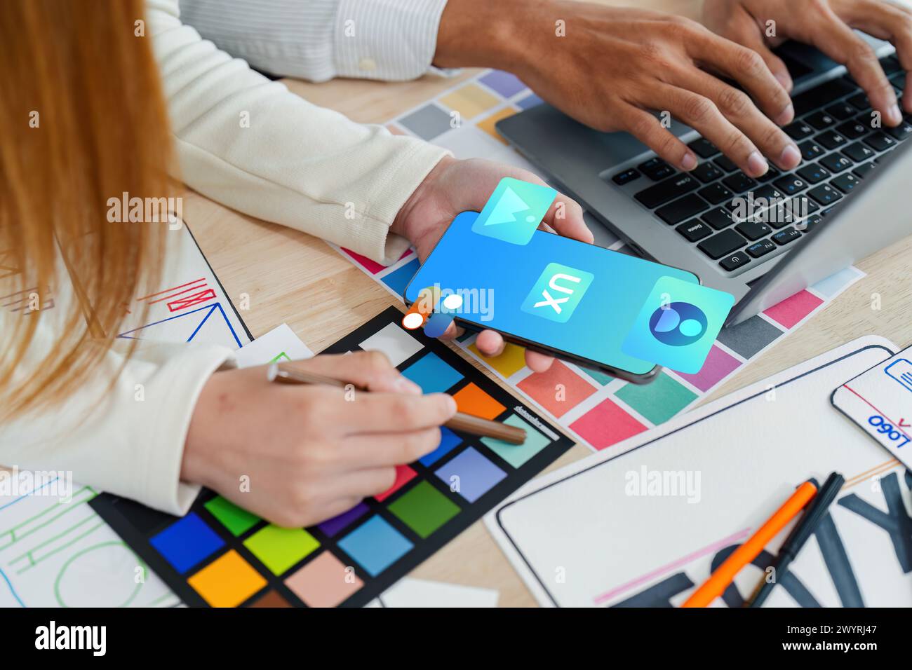 UI designer and UX developer brainstorm idea to design the application interface. Creative ...