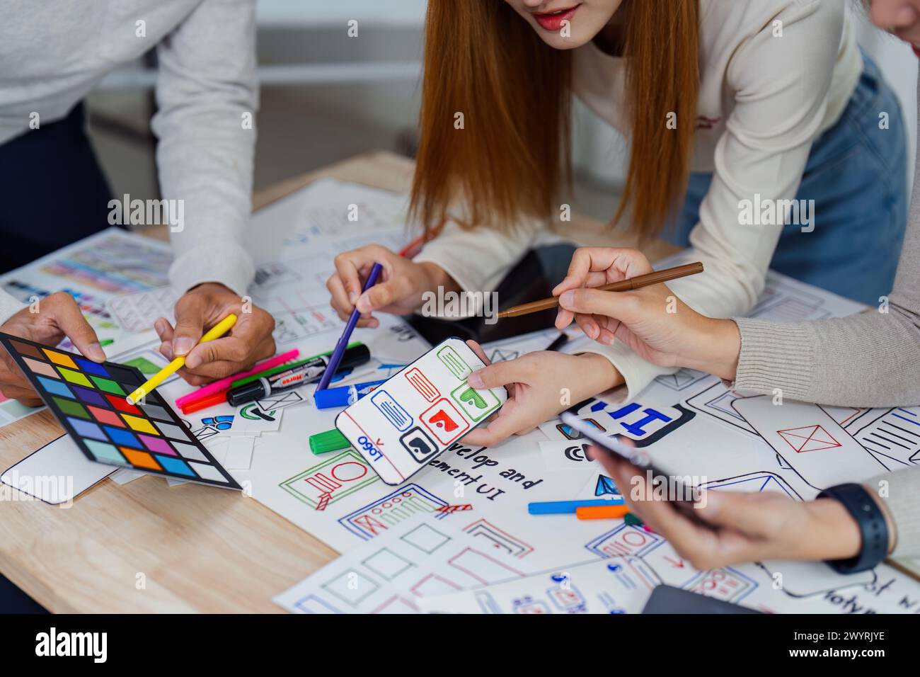UI designer and UX developer brainstorm idea to design the application ...