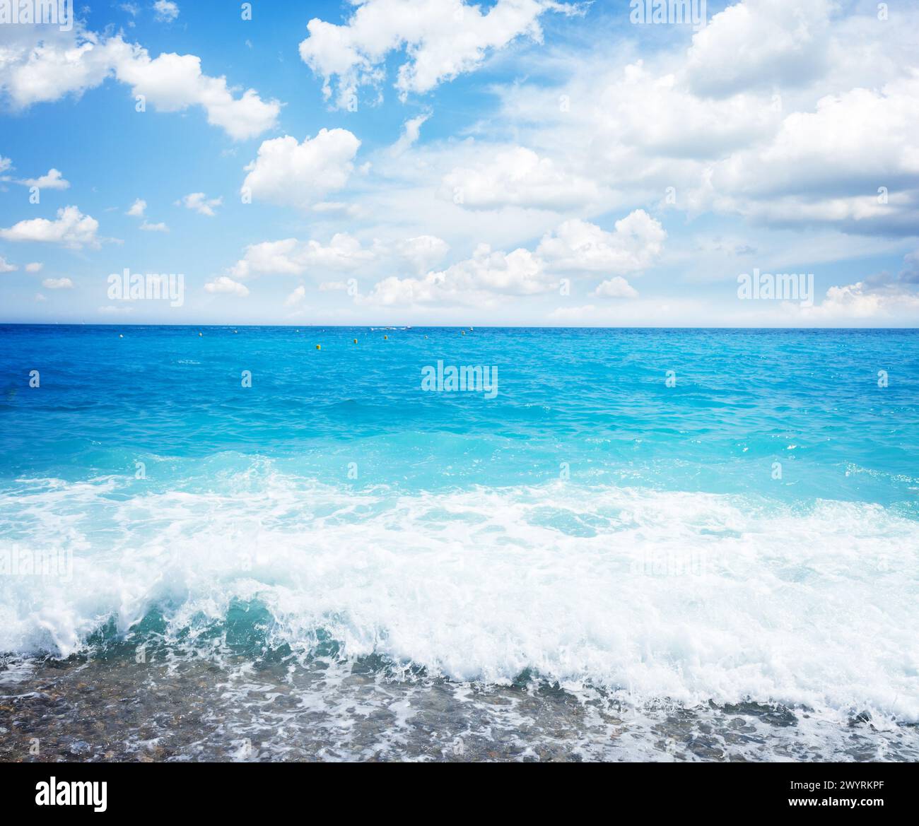 stone beach and turquiose water splash of cote dAzur at summer day ...
