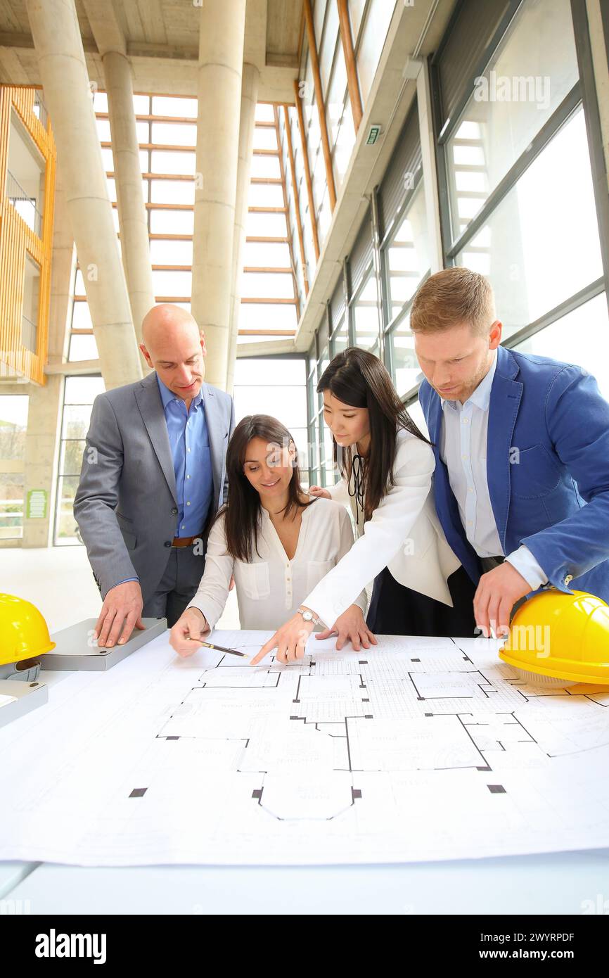 Architects looking at blueprints Stock Photo - Alamy