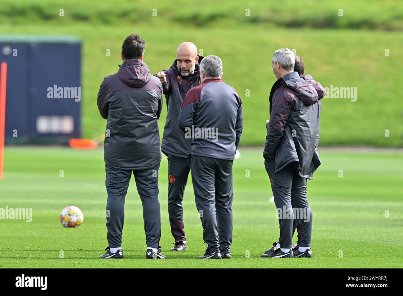 Pep Guardiola manager of Manchester City speaks with his coaching team ...