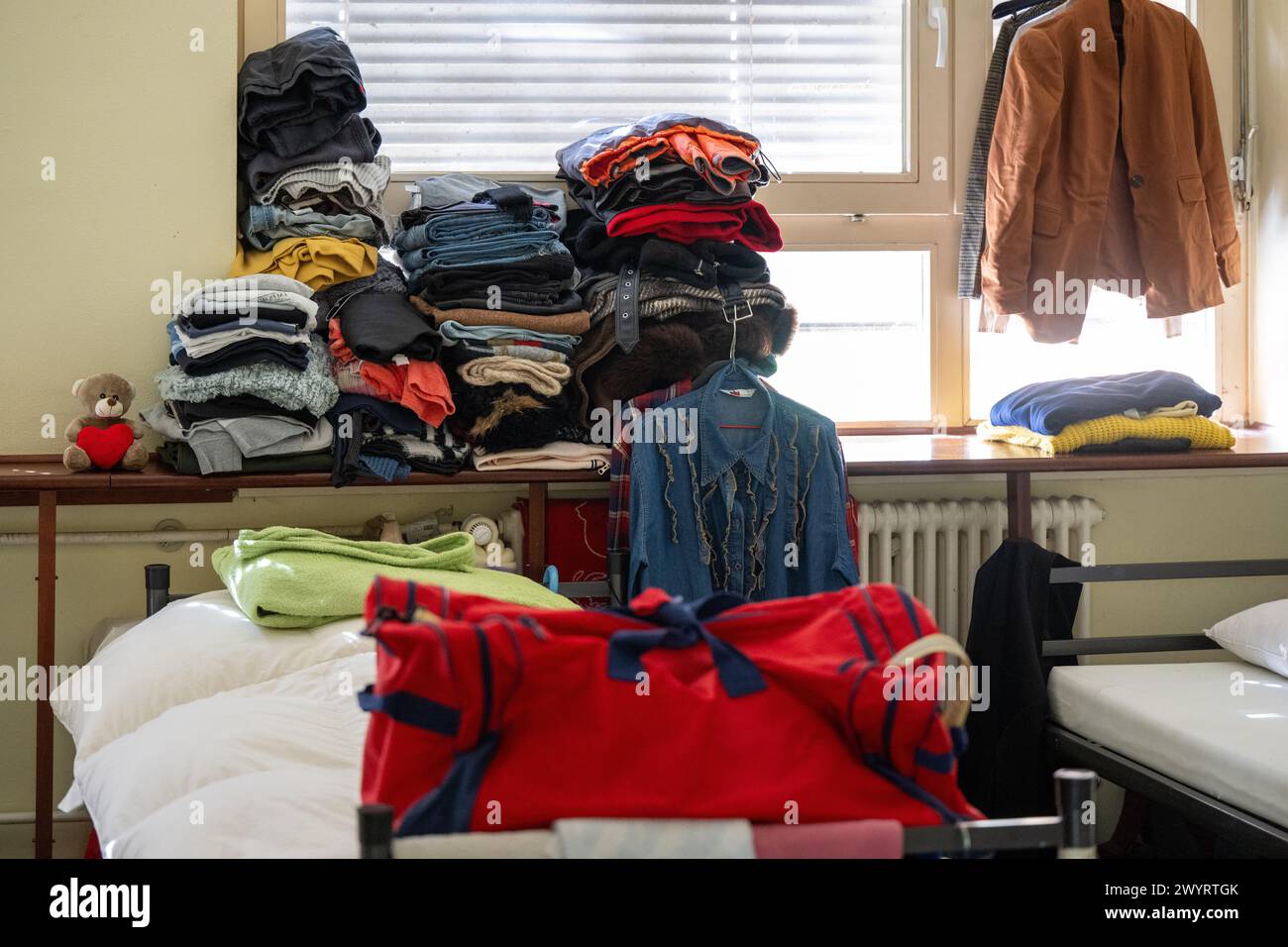 08 April 2024, Berlin: The clothes of a homeless woman lie on a window ...