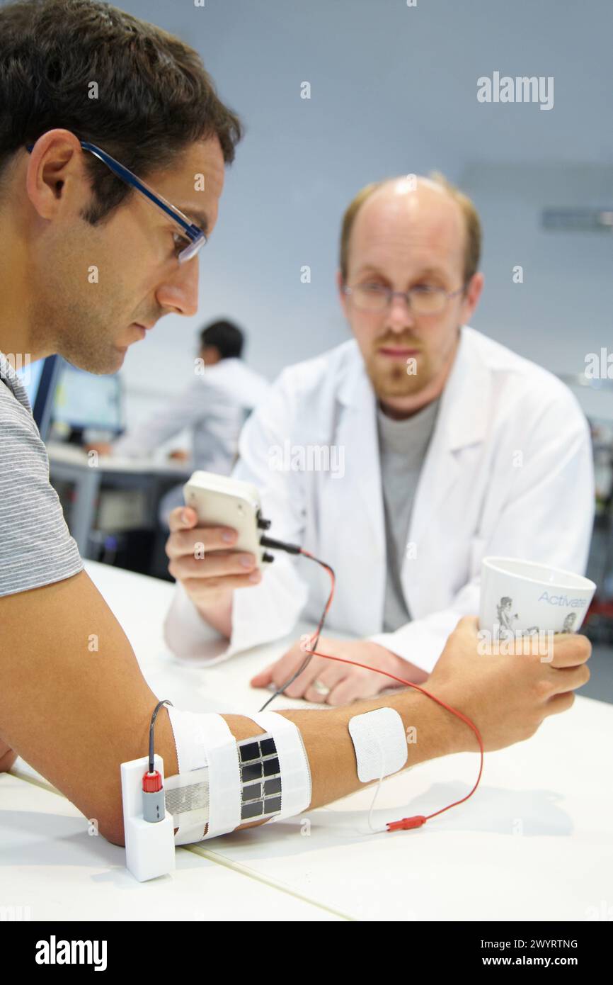 Researcher placing multipad electrodes in the control arm for the ...