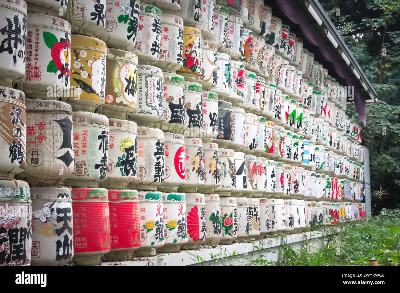 In this vibrant display, traditional Japanese sake barrels stand in ...