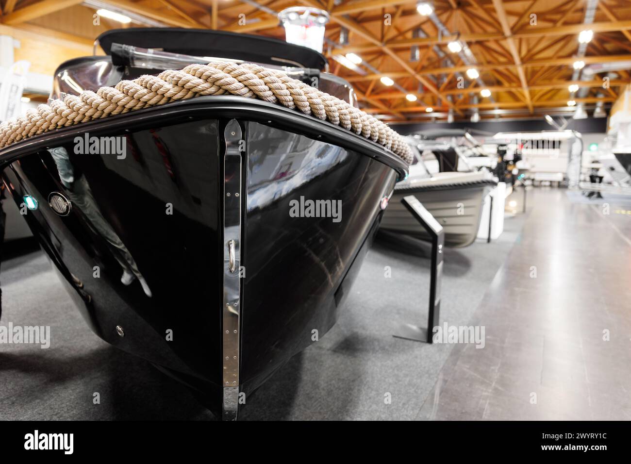 Many small big ship yachts at boat show exhibition indoors hall. Marine ...