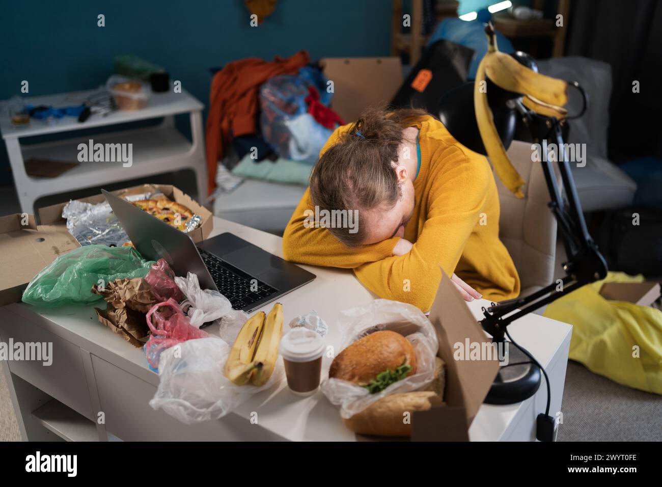 Tired student sleeping while preparing for exams in dirty, messy room ...
