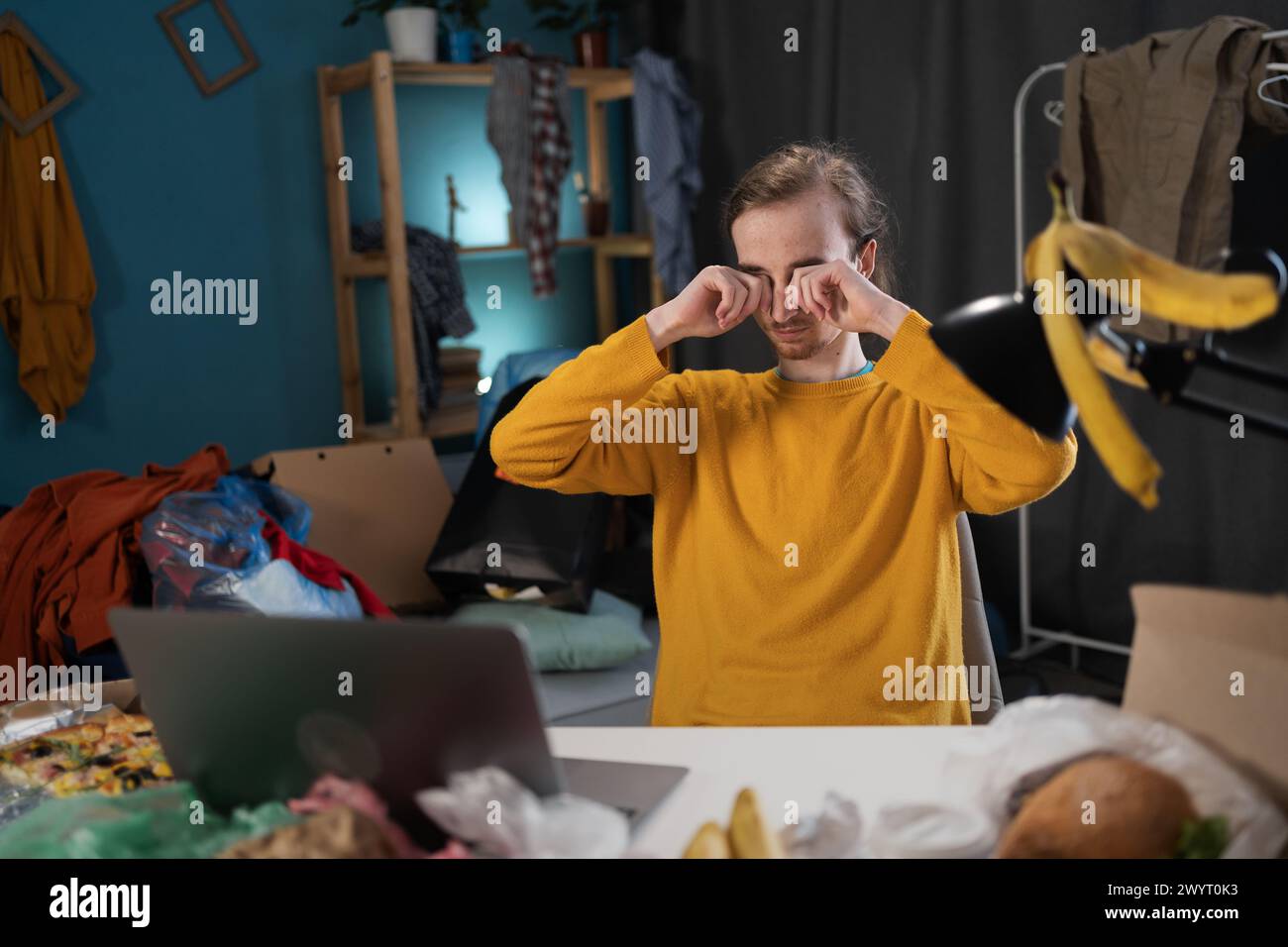 Tired young man working at home feel pain eyestrain rubbing dry ...