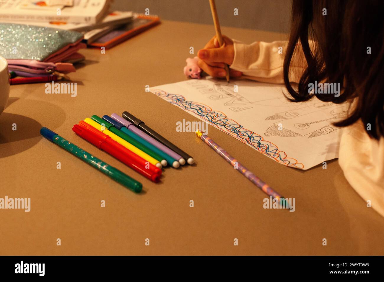 Girl's hands coloring a drawing with her paints Stock Photo - Alamy