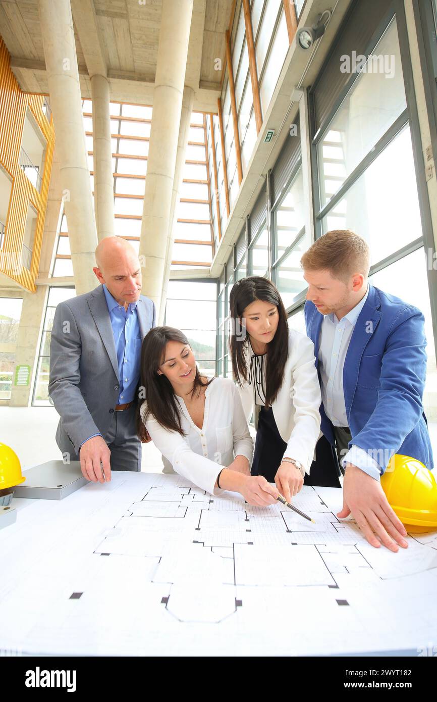 Architects looking at blueprints Stock Photo - Alamy