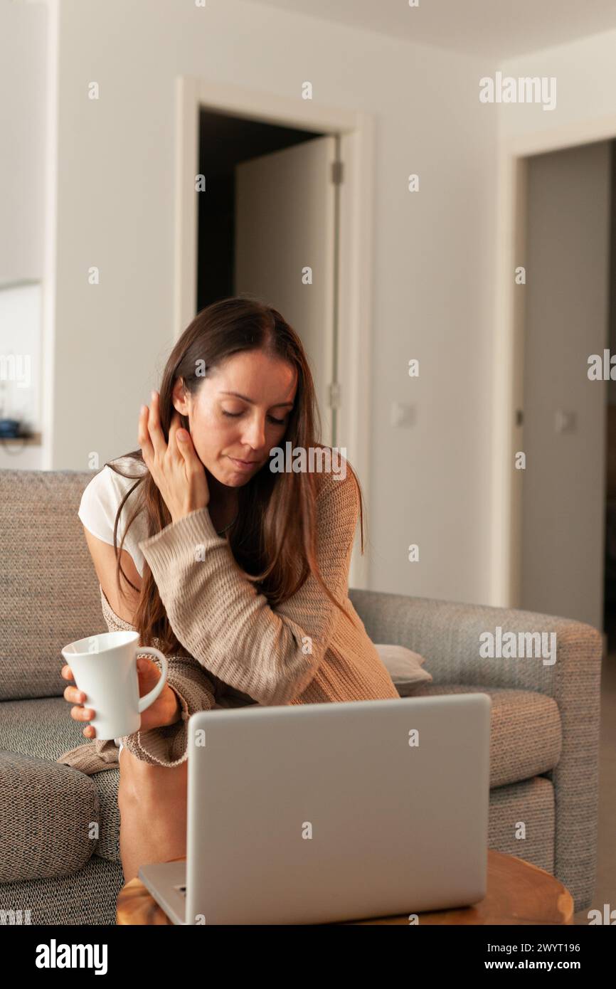 Woman taking a break from teleworking with a cup of coffee Stock Photo - Alamy