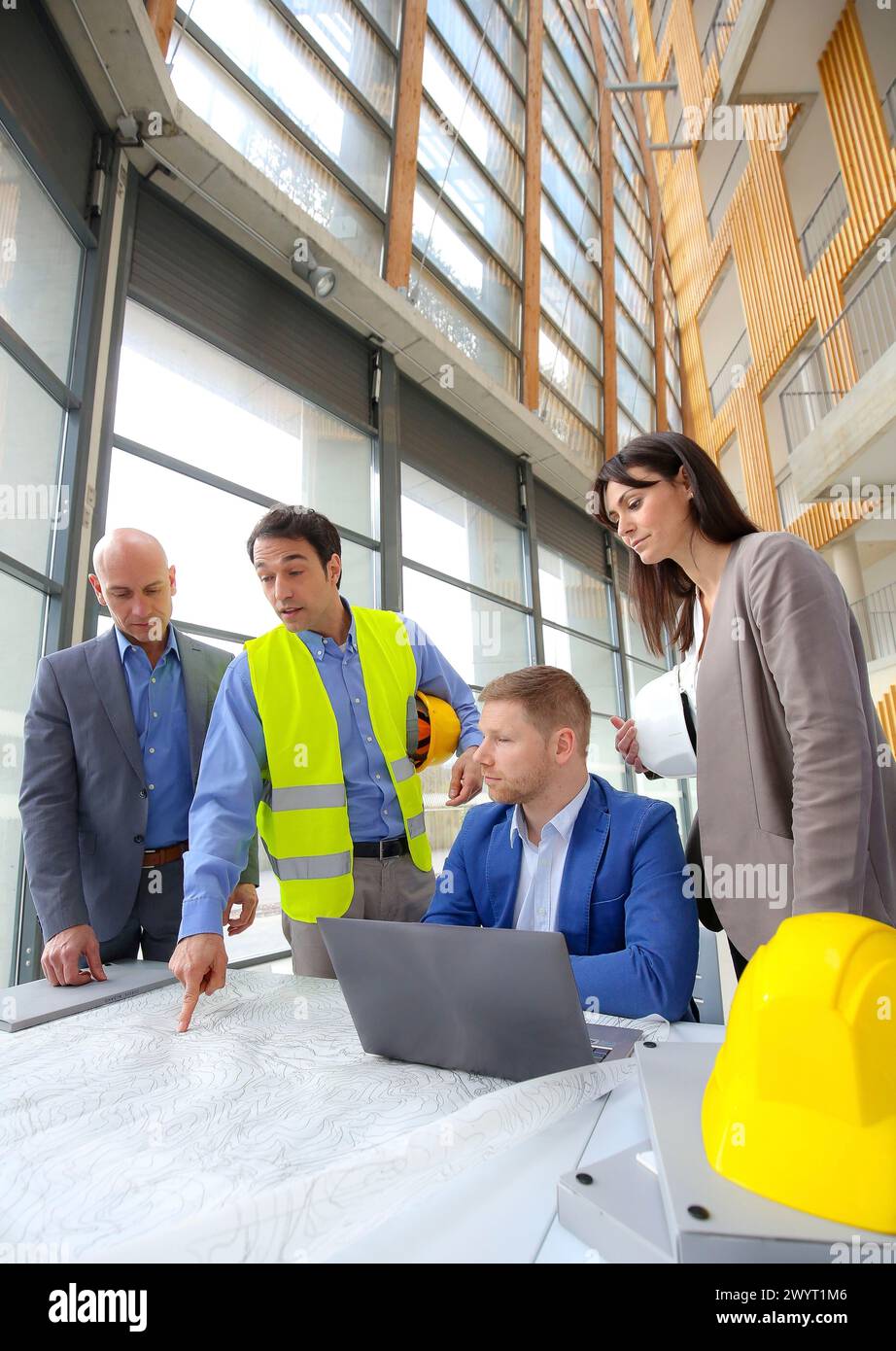 Engineers looking at map Stock Photo - Alamy