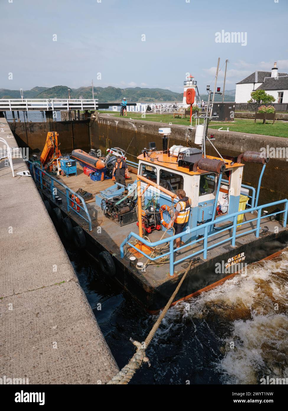 A working boats exits the Crinan Basin Canal Sea Lock heading out into ...