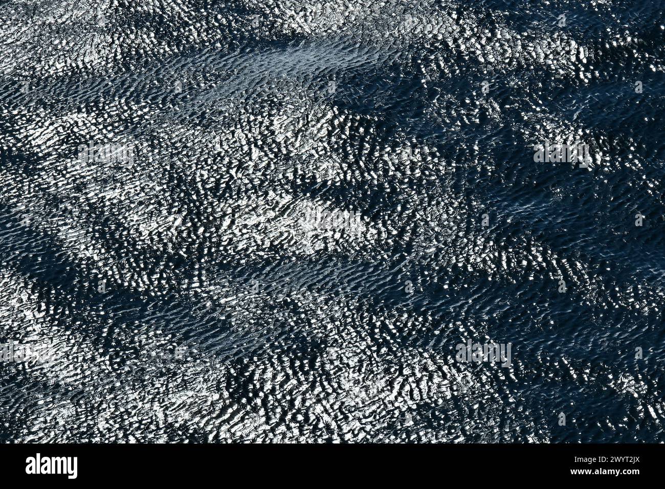 Wind blows texture and shape making ripple patterns on dark, emerald ...