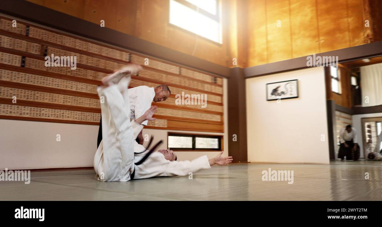 Black belt students, throw or sensei in dojo to start practice lesson ...