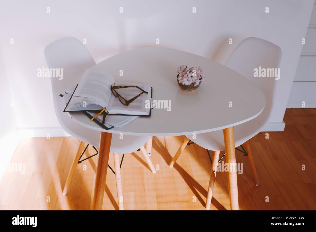 round table in interior with parquet floor and white wall Stock Photo ...