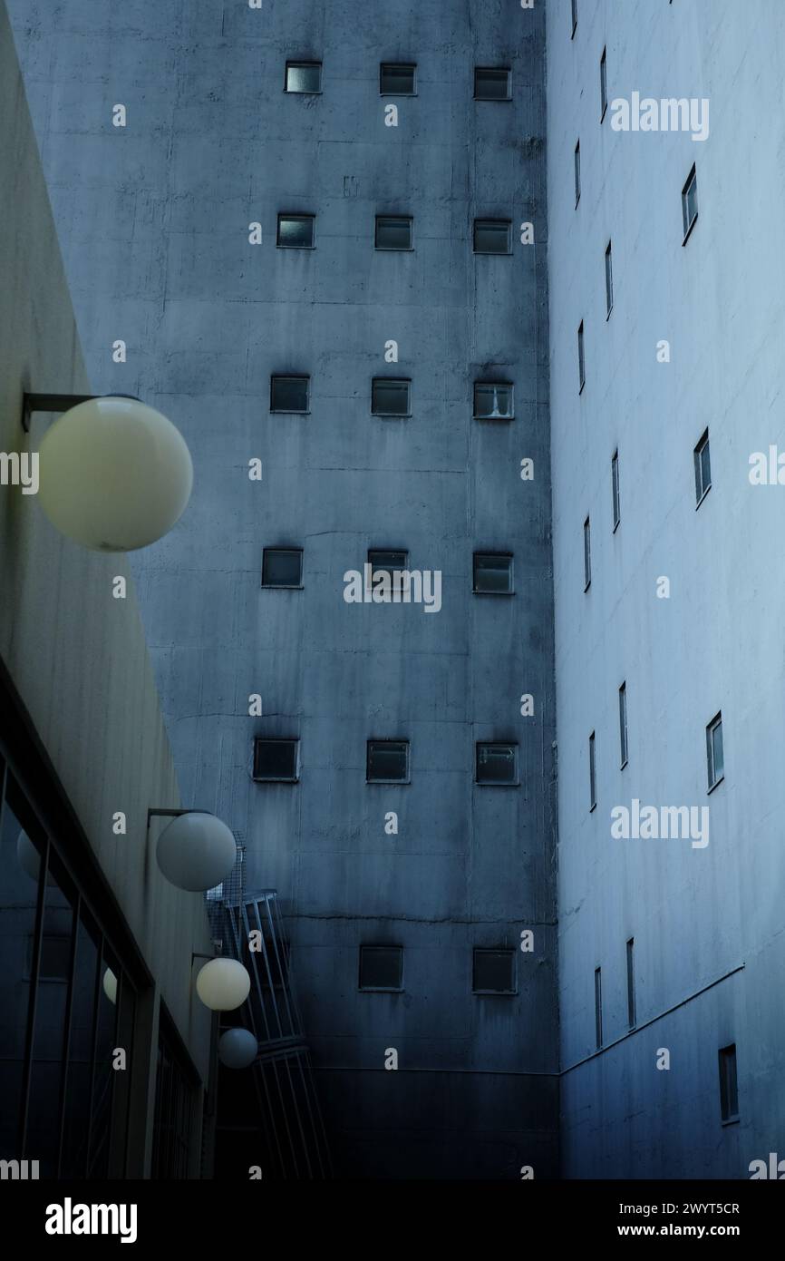 A dystopian looking commercial high-rise building with ball lamps in a ...