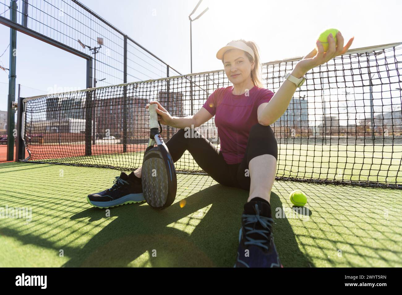 Sporty european woman padel tennis player trains on the outdoor court ...