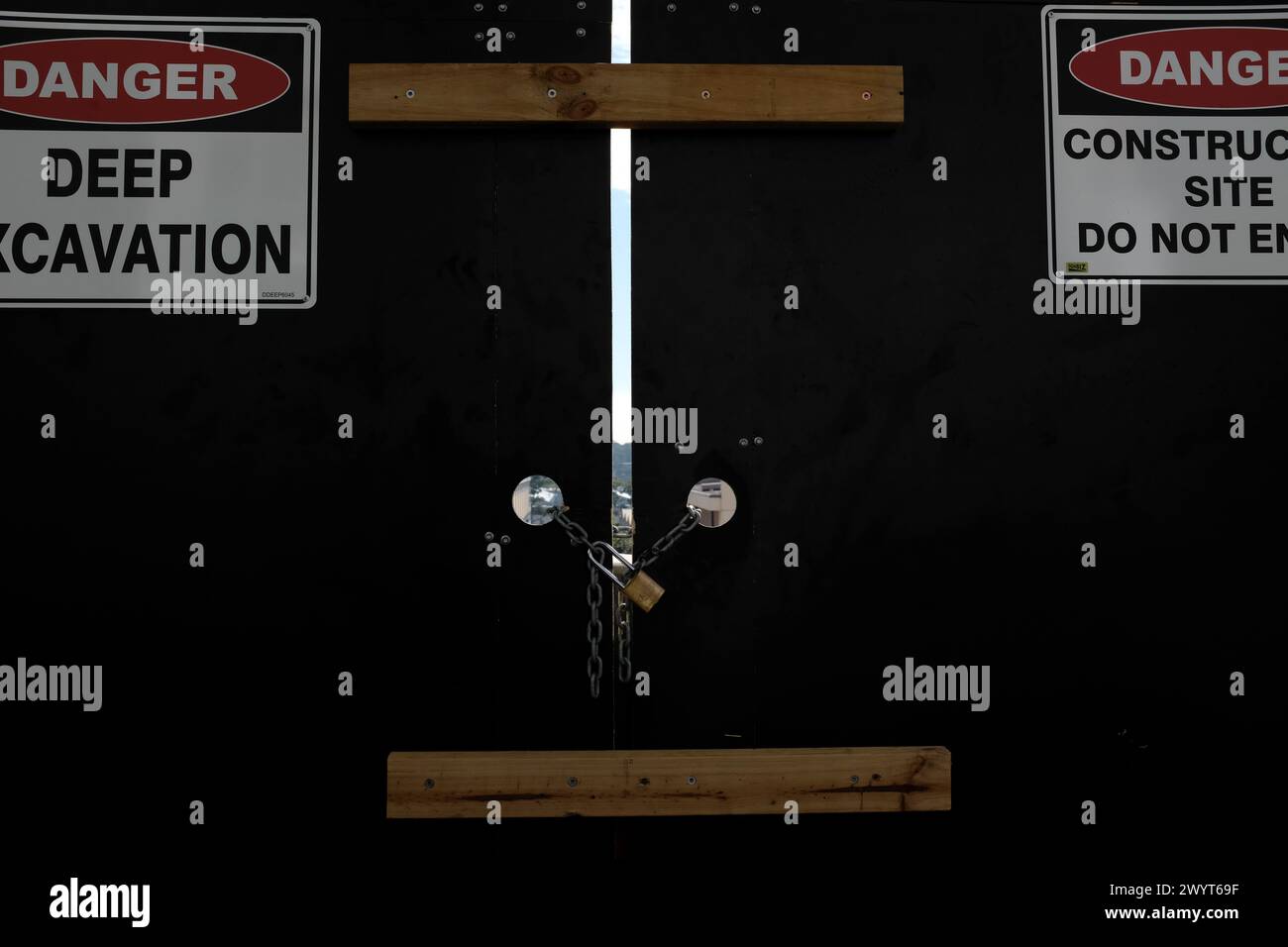 Black hording doorway with Danger - Deep Excavation signs, the doors ...