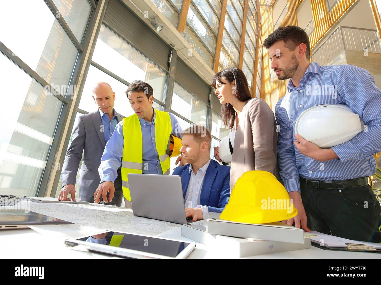 Engineers looking at map Stock Photo - Alamy