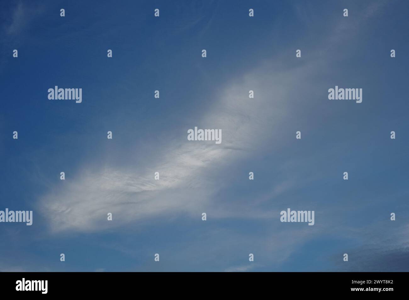 A bight white oblong of soft white Cirrus cloud, wisps and skeins of ...