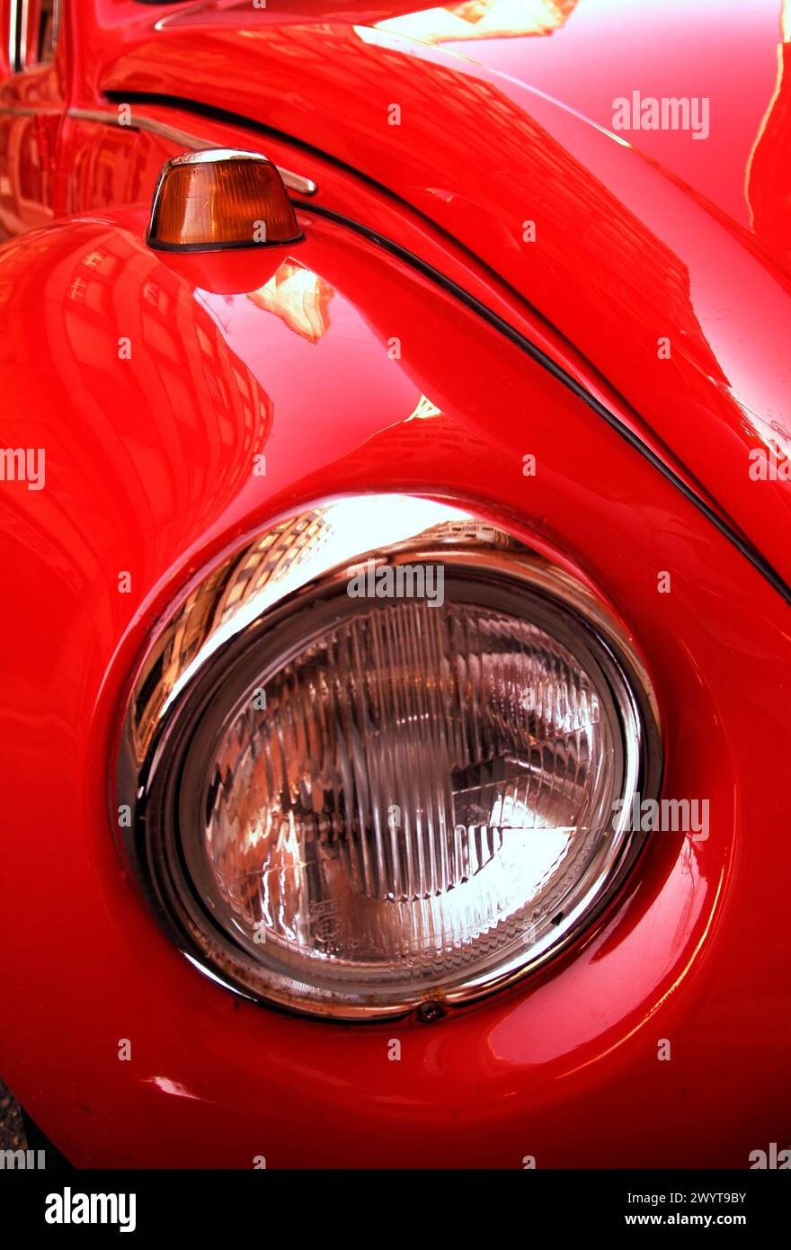 Detail of the round headlight of a red car with rounded lines Stock ...
