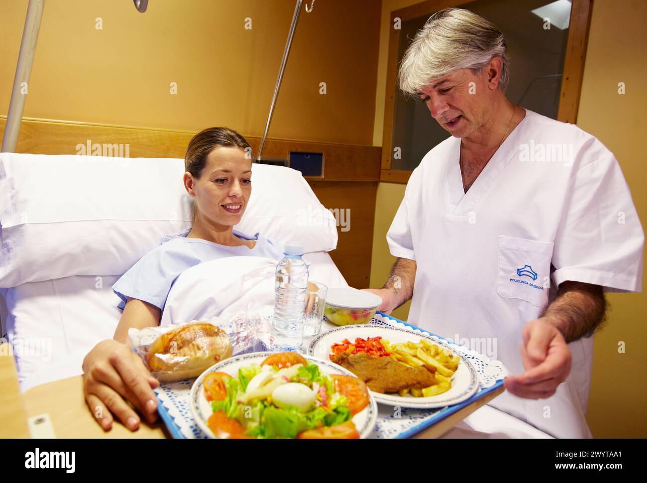Nurse with food tray and patient in a hospital room. Hospital ...