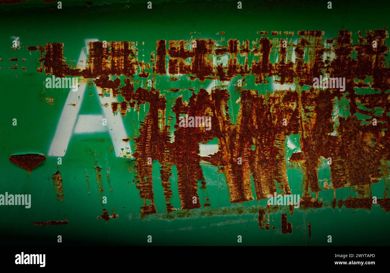 white label at a green container surface, lettering an "A" and some ...