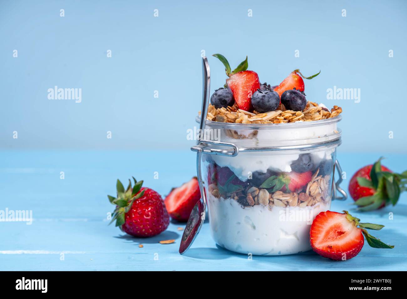 Summer berries granola breakfast layered dessert with yogurt, oat multi ...