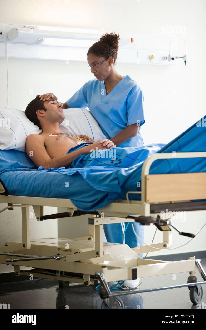 Nurse touching forehead patient hi-res stock photography and images - Alamy