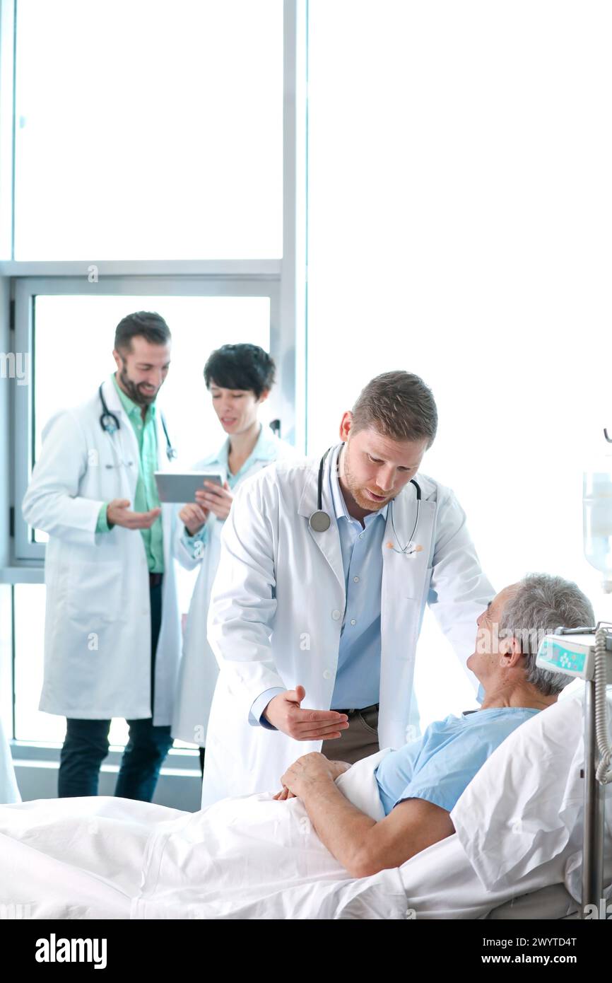 Patient in hospital room attended by a doctor, Hospital Stock Photo - Alamy