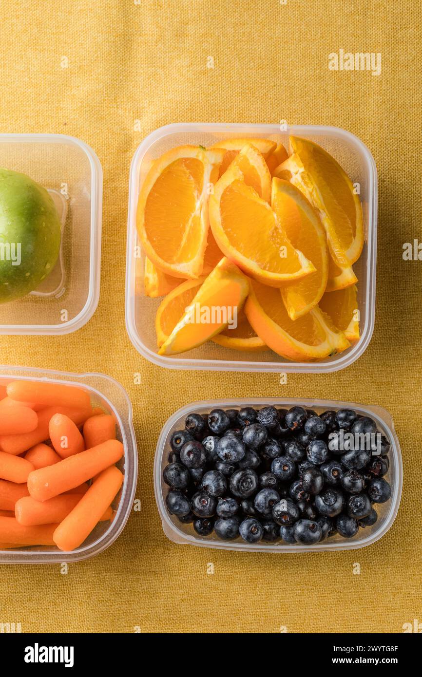 Lunch box with healthy snacks. Plastic container with fruits and ...