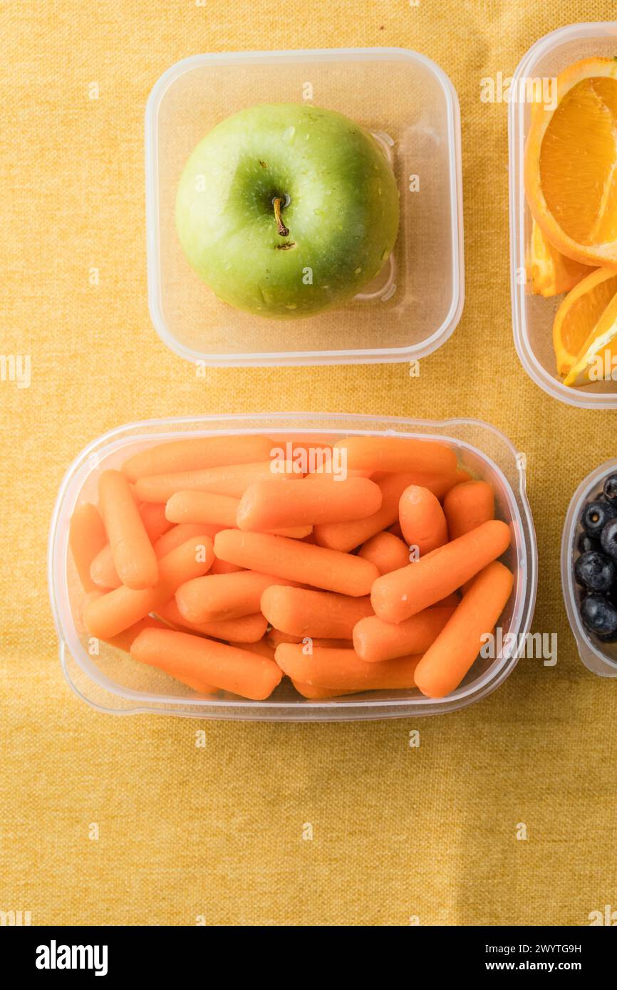Lunch box with healthy snacks. Plastic container with fruits and ...