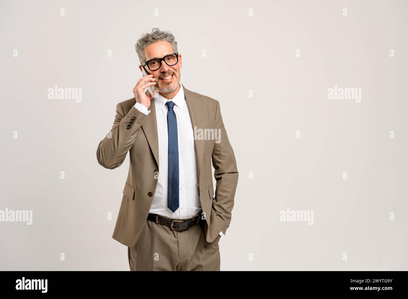 Confident senior businessman in professional attire actively ...