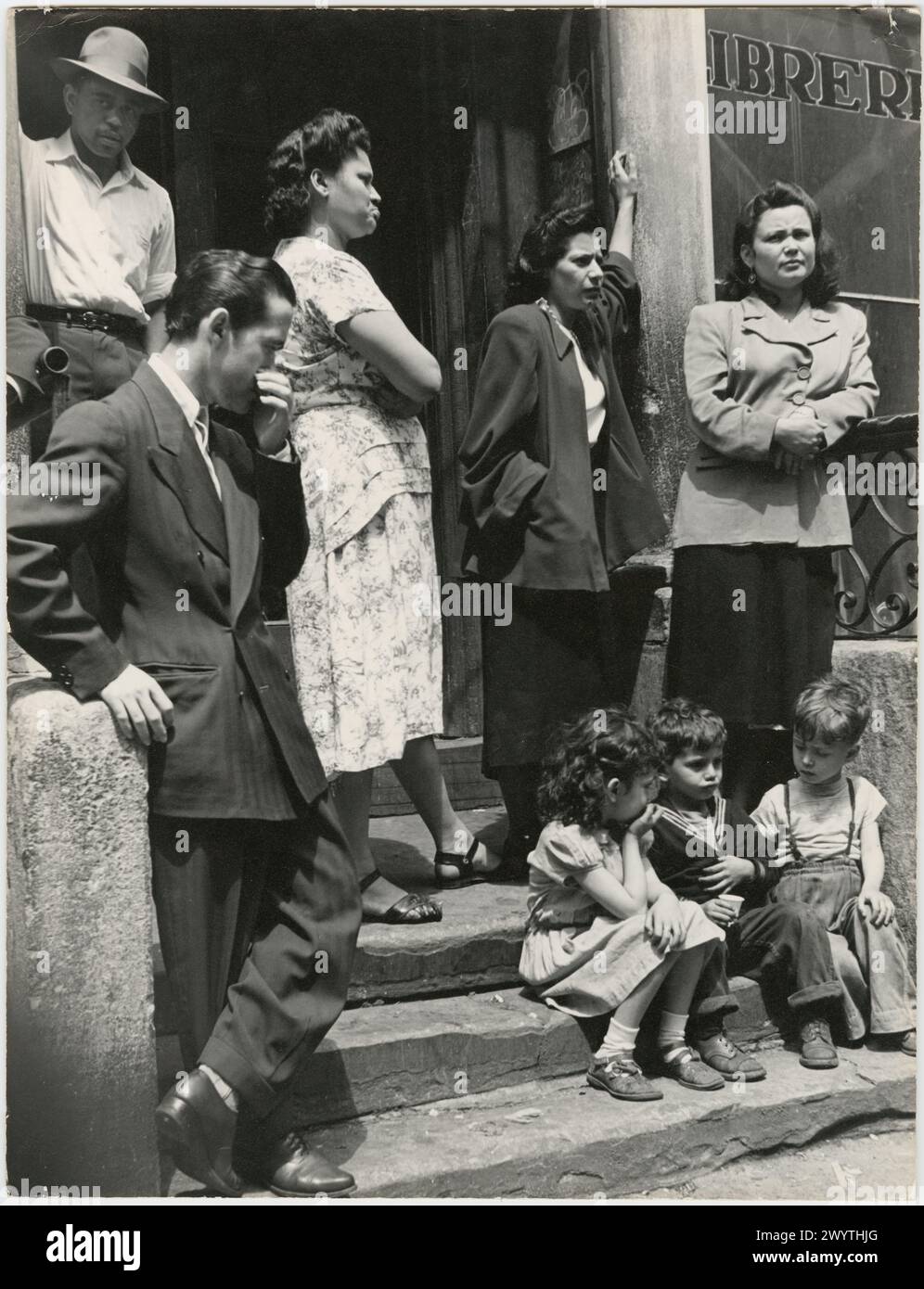 Group of men, women and children gathered on stoop, East Harlem, New ...