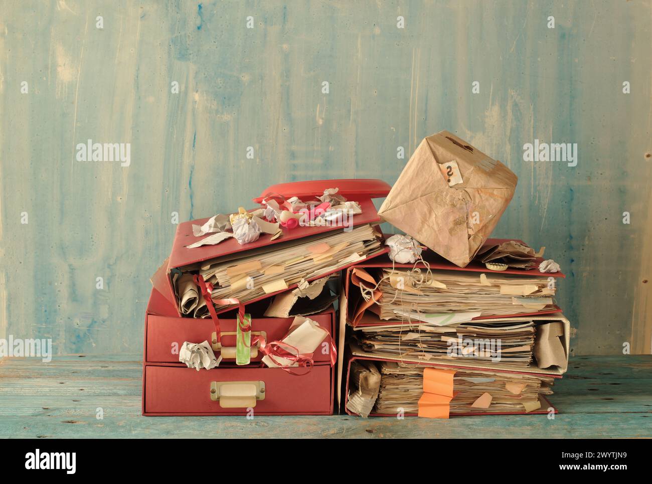 messy file folders and storage boxes in a cluttered office ,red tape ...