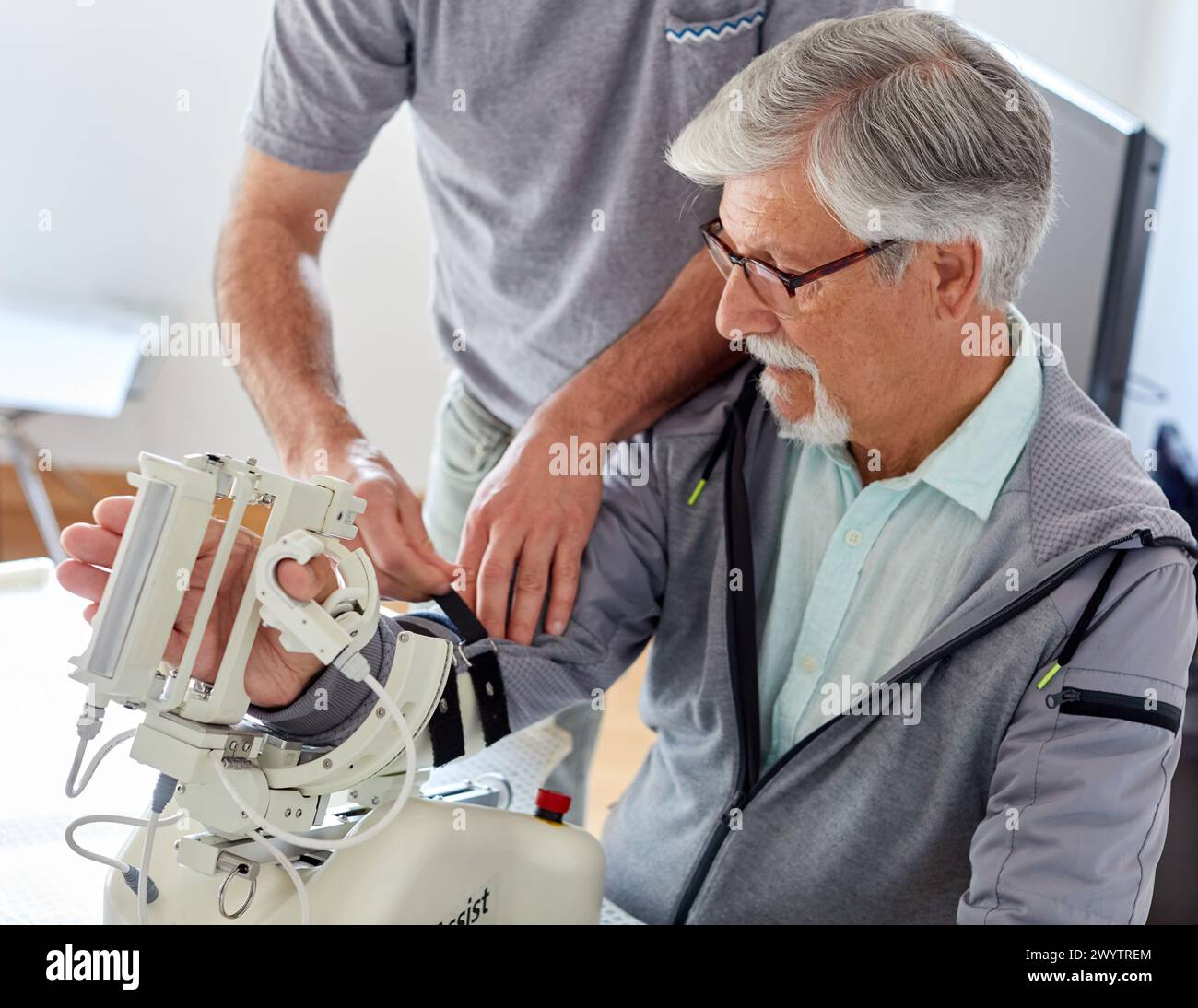 Patient with assistive robot for upper limb rehabilitation, The robot ...