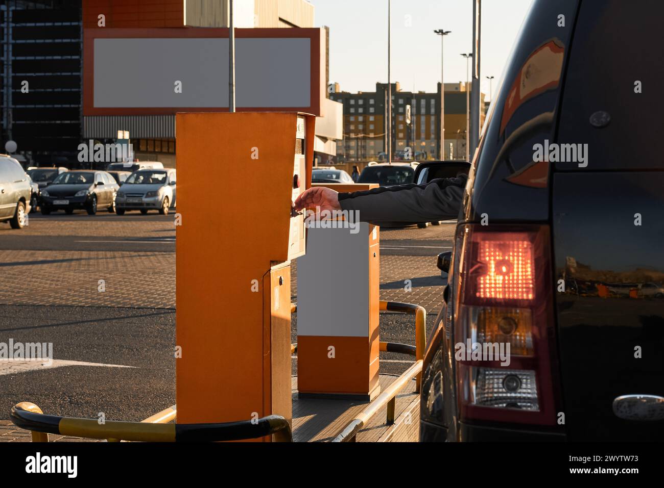 Man's hand take ticket in control tickets machine at vehicle entrance ...