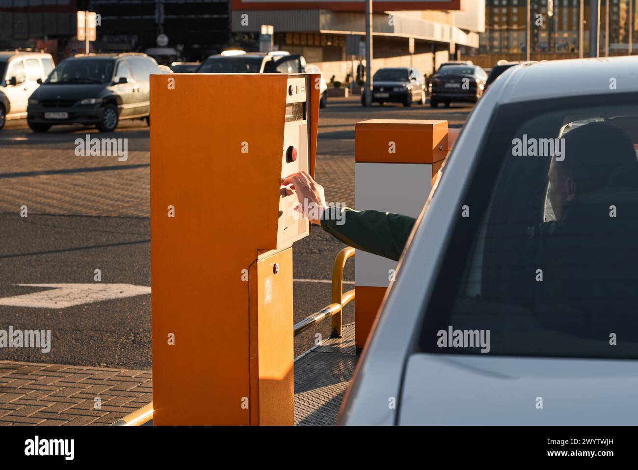 Man's hand take ticket in control tickets machine at vehicle entrance ...