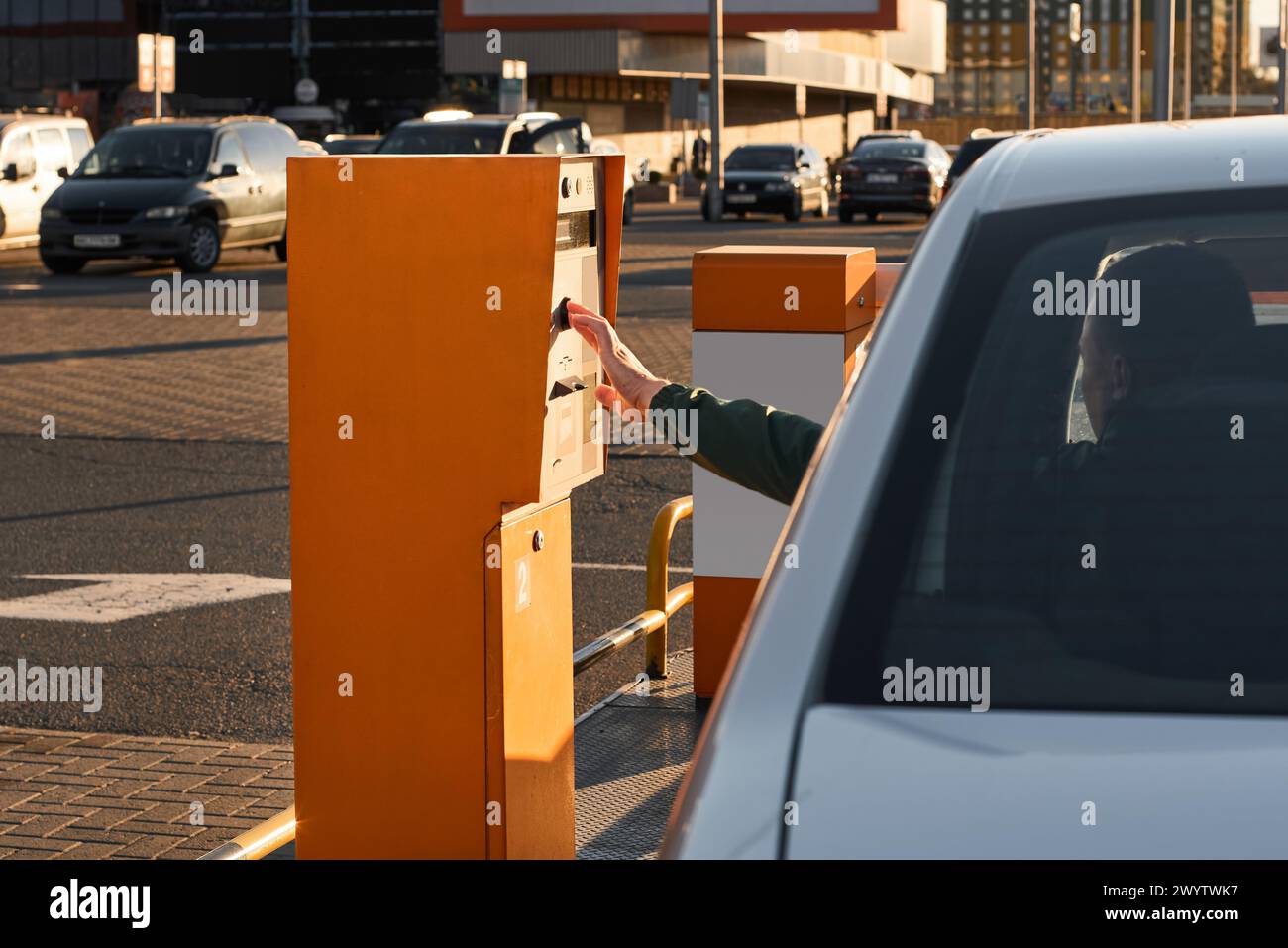 Man's hand take ticket in control tickets machine at vehicle entrance ...